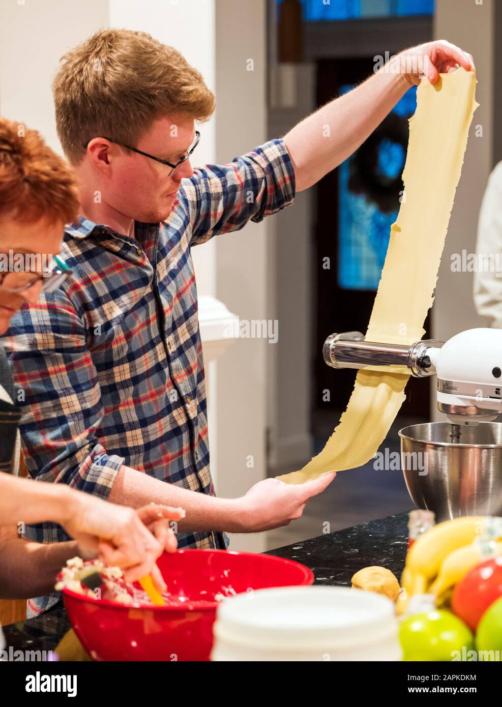 Mother and adult son preparing homemade pasta Stock Photo - Alamy