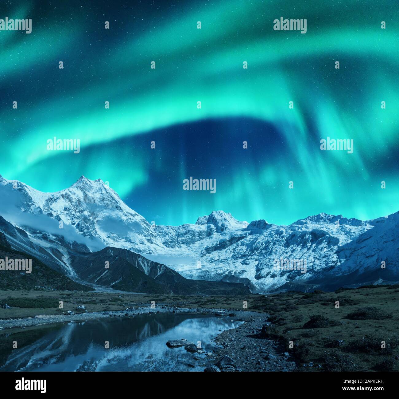 Northern lights above snow covered rocks. Winter landscape Stock Photo ...