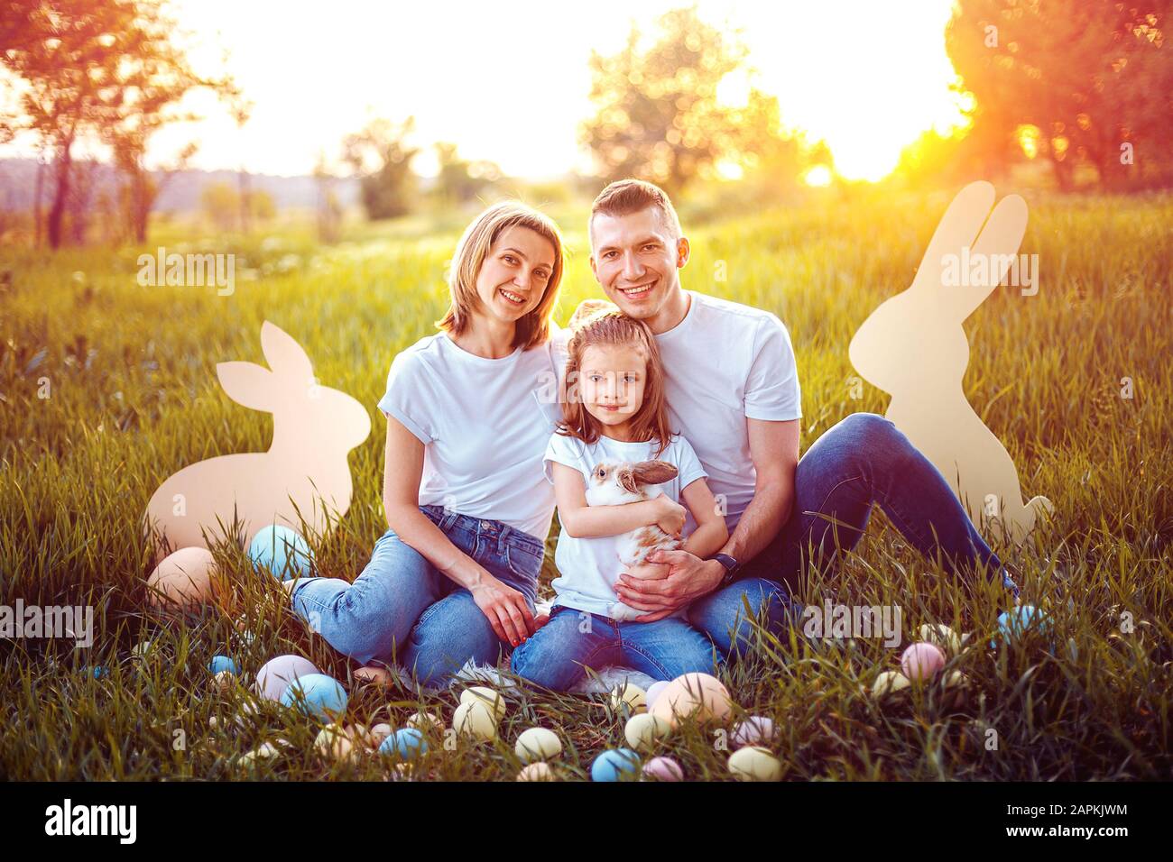 Little girl and her parents play with the rabbit. happy little girl ...
