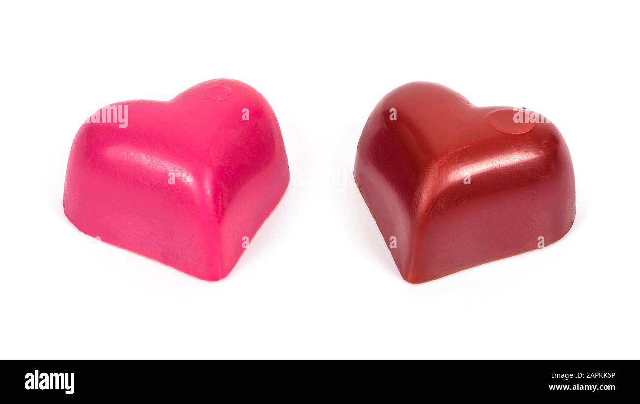 Two heart shaped chocolates in a row isolated on white background with ...