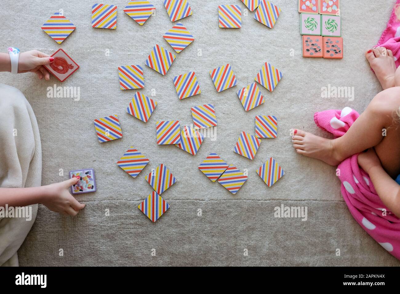 overhead view of kids playing card game sitting on a rug Stock Photo ...