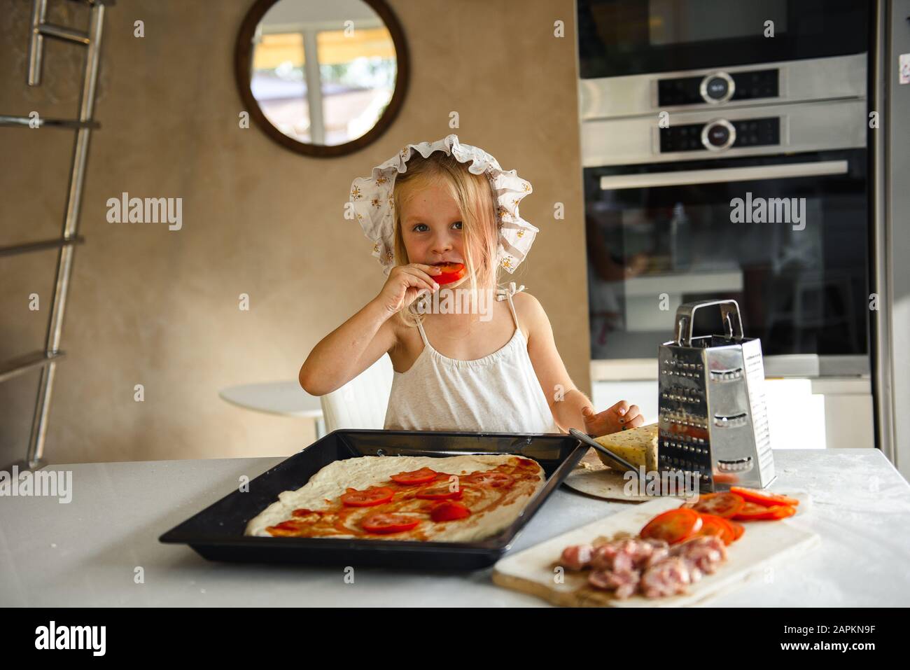 Little girl cooking pizza in the kitchen Stock Photo - Alamy