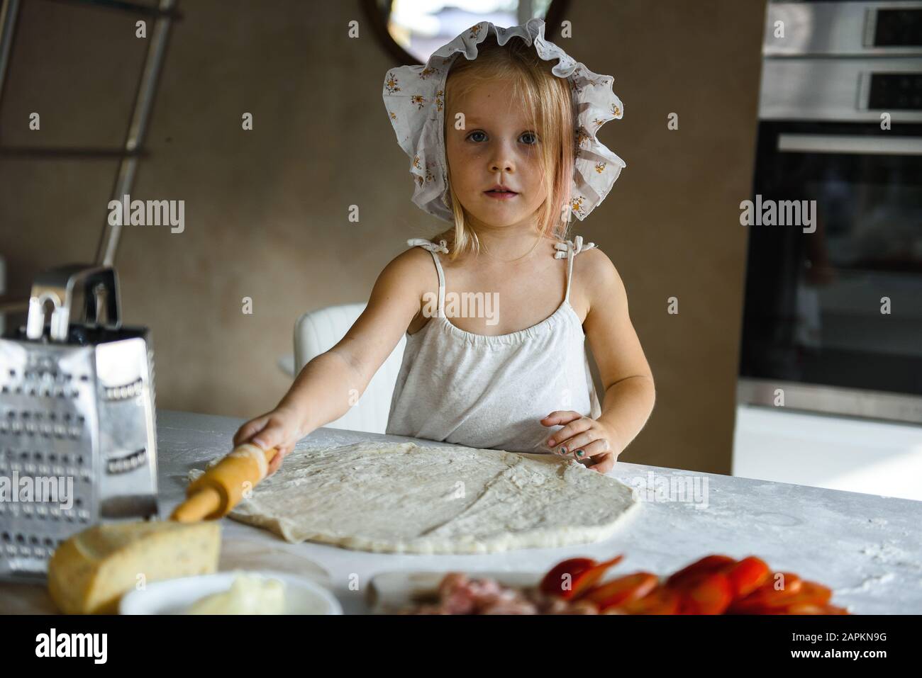 Little girl cooking pizza in the kitchen Stock Photo - Alamy