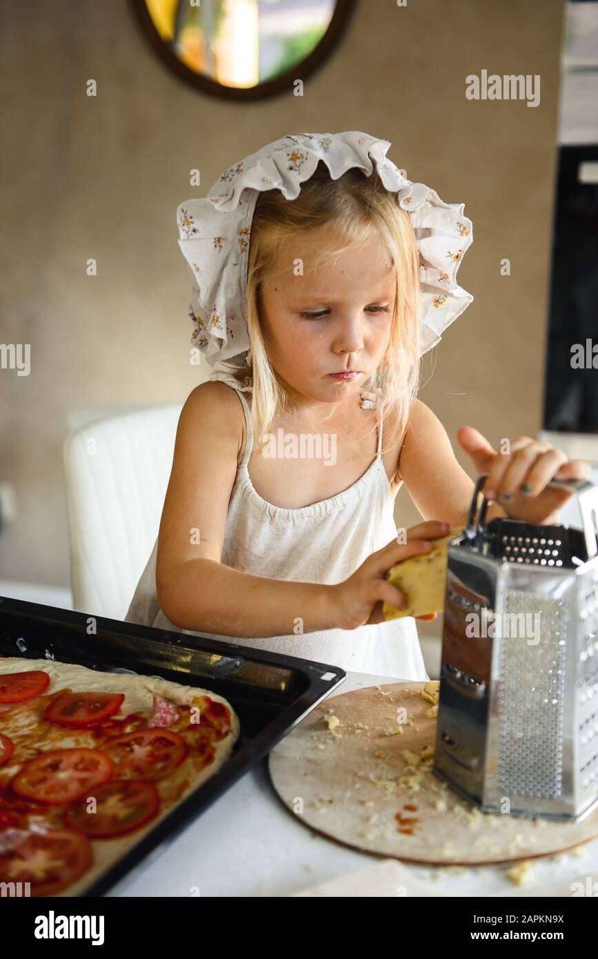 Little girl cooking pizza in the kitchen Stock Photo - Alamy
