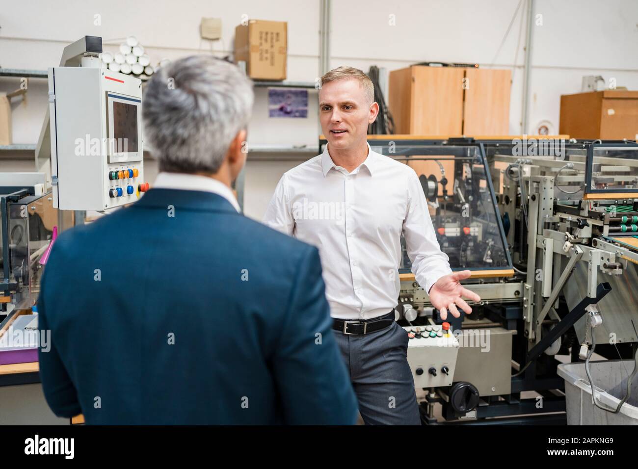 Industrial employees talking in factory hi-res stock photography and ...