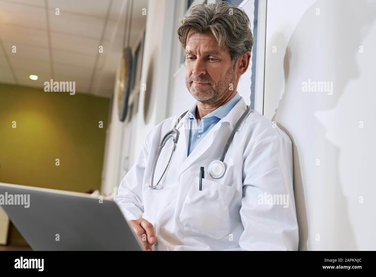 Doctor using laptop in his medical practice Stock Photo - Alamy