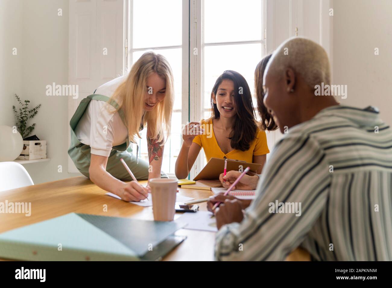 Businesswomen having a meeting and taking notes in office Stock Photo ...