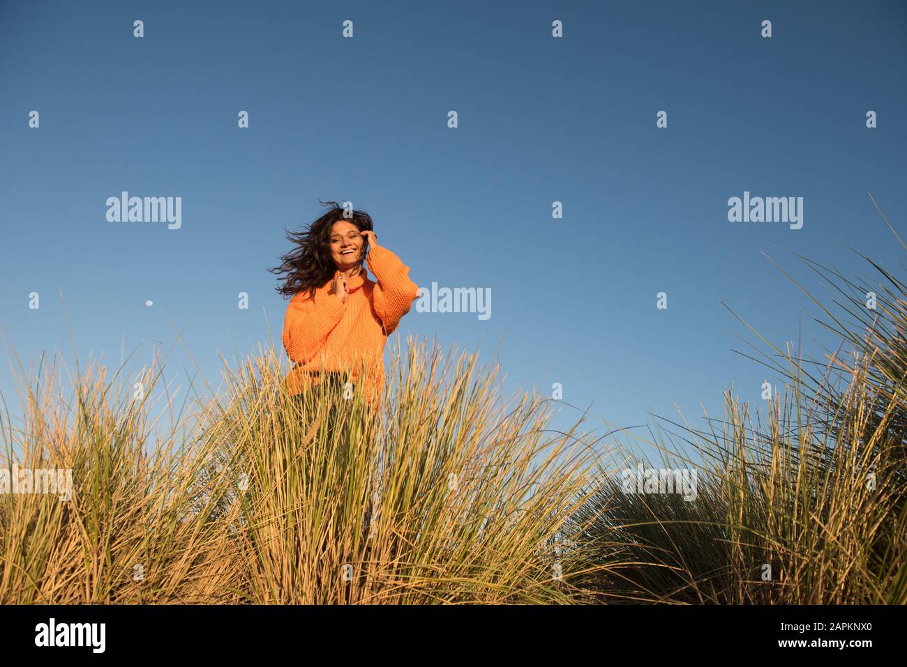 Happy female tourist smiles in the wind Stock Photo - Alamy