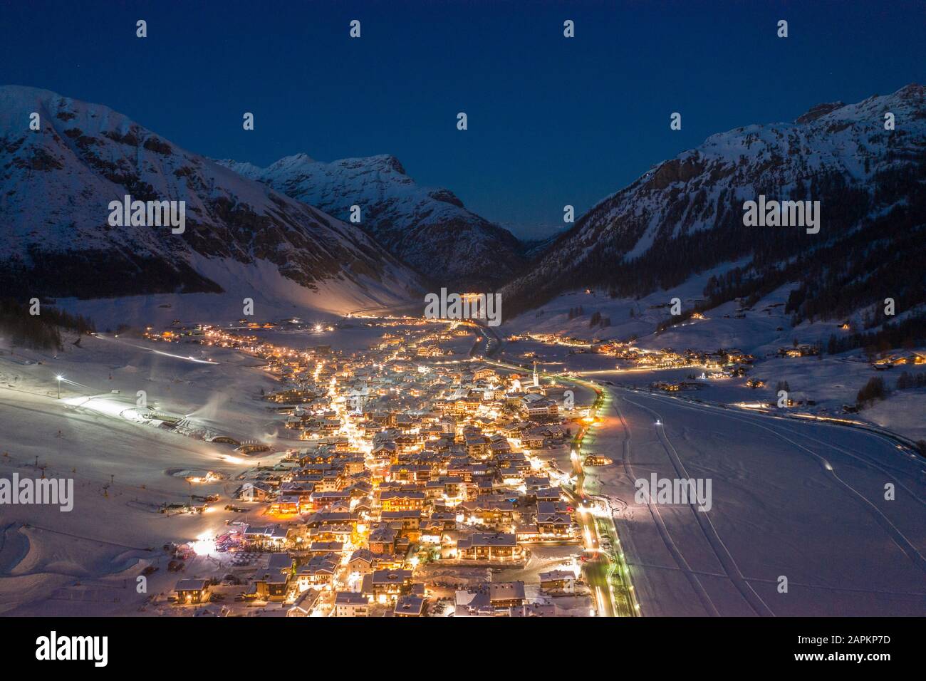 Italy, Province of Sondrio, Livigno, Aerial view of illuminated town in ...