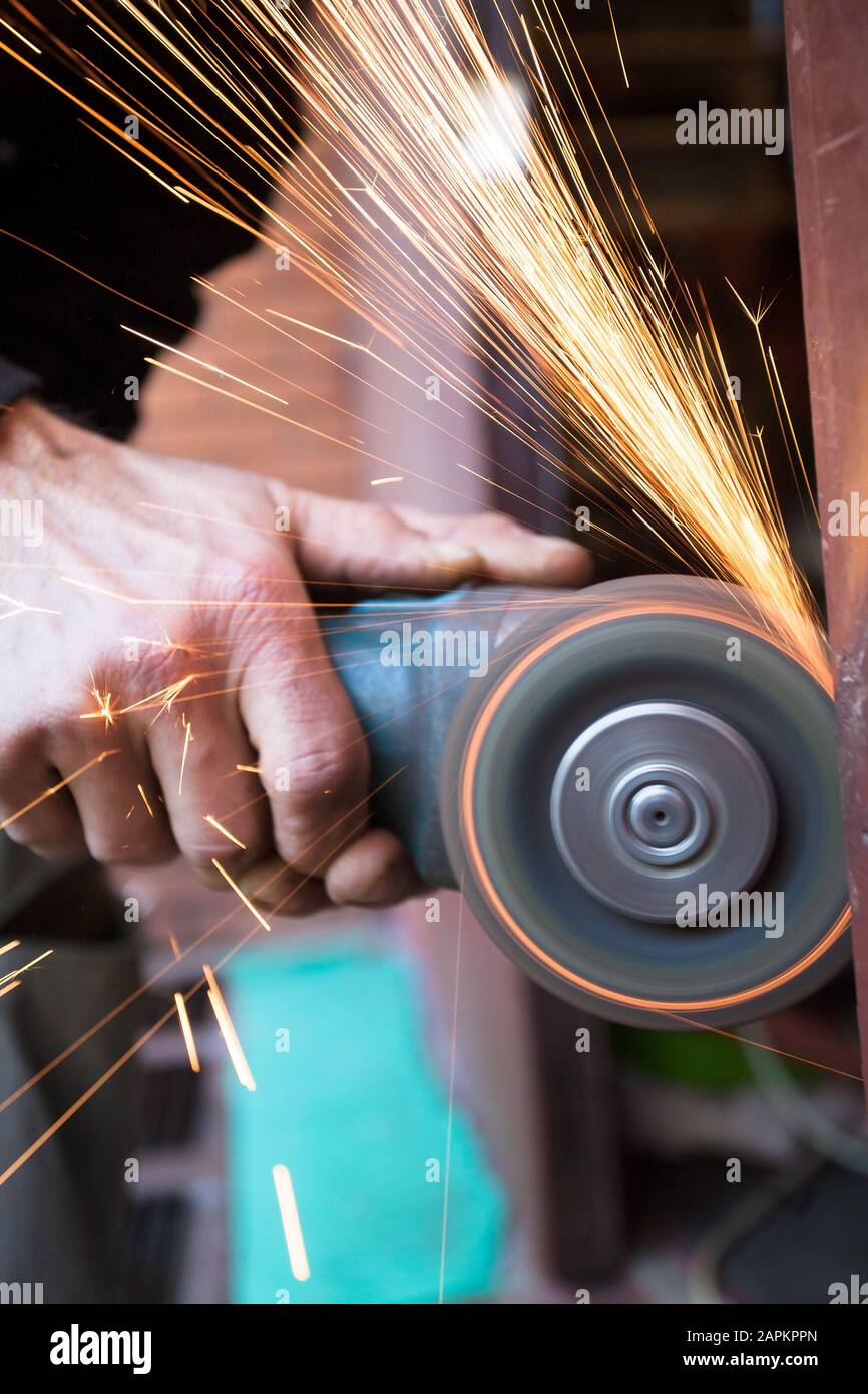 using angle grinder to cut metal Stock Photo - Alamy