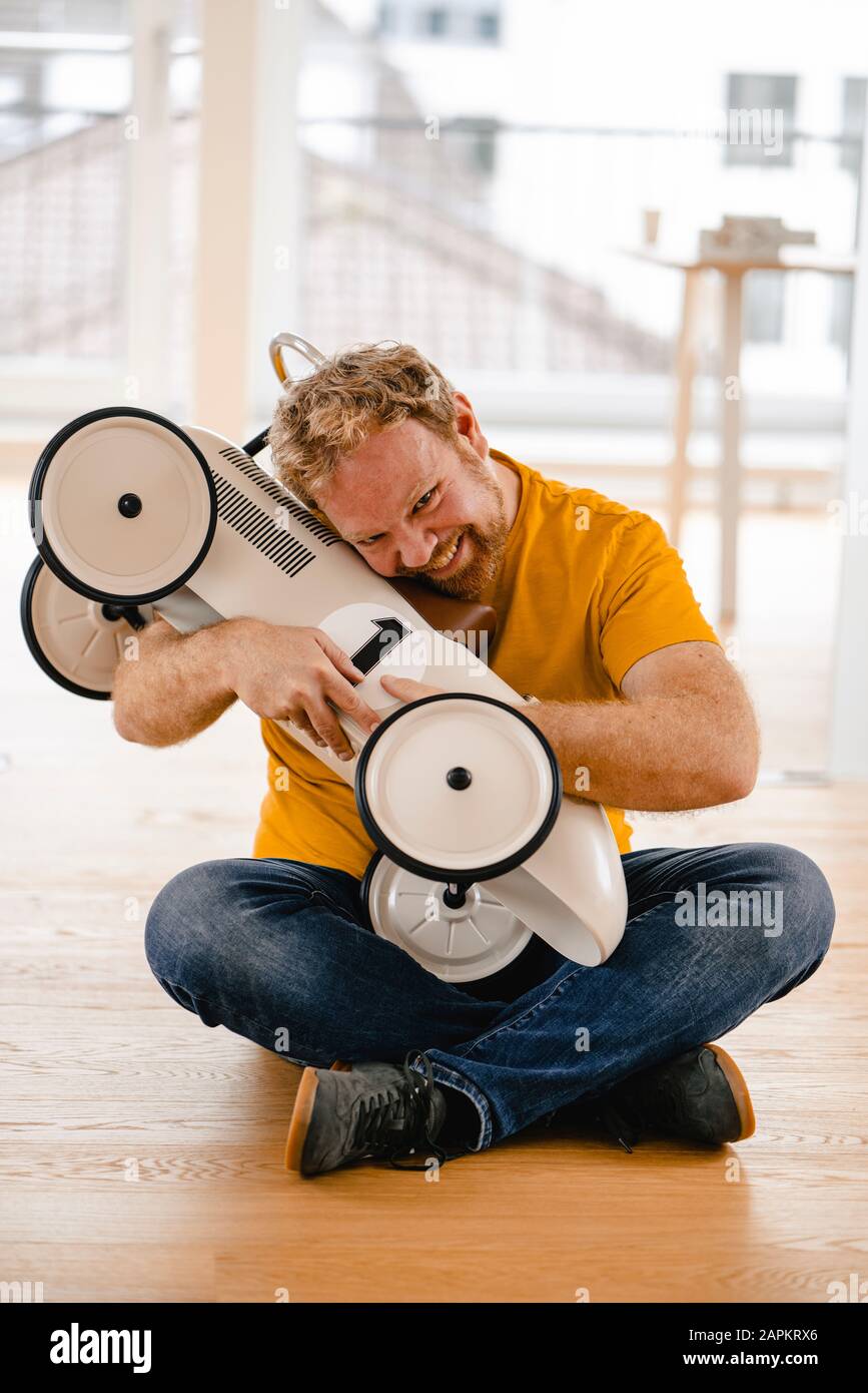 Happy man hugging toy car Stock Photo - Alamy