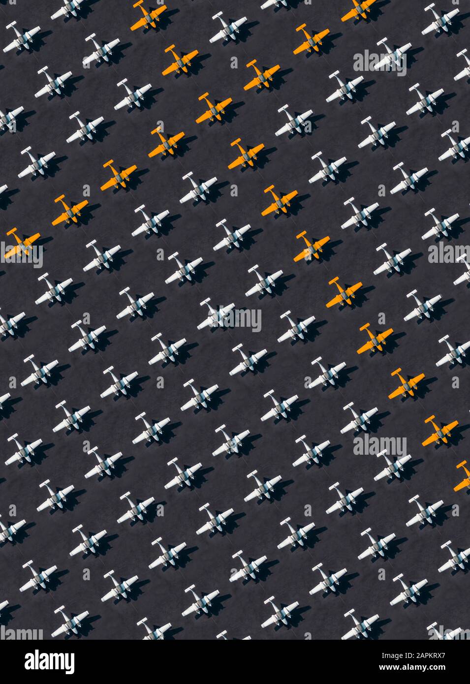 Aerial view of arrangement of white and orange colored airplanes in ...