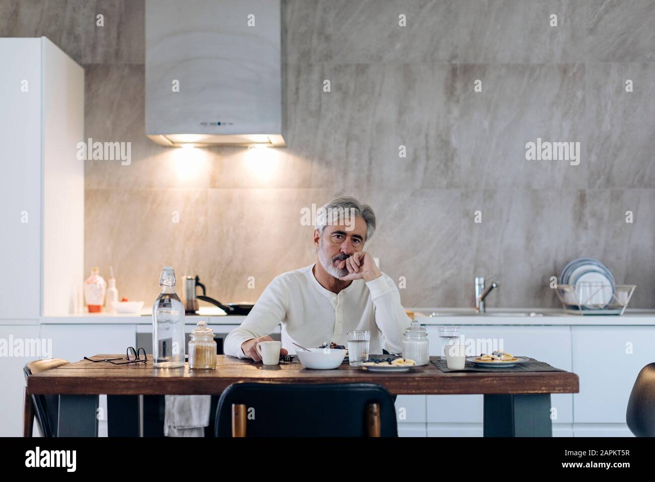 Man head in hands dining table hi-res stock photography and images - Alamy
