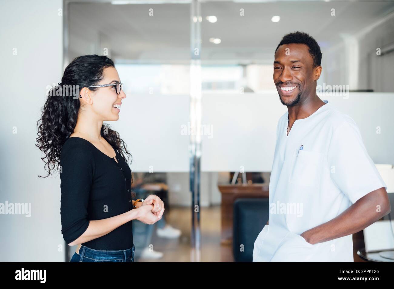 Smiling dentist with patient in dental surgery Stock Photo - Alamy