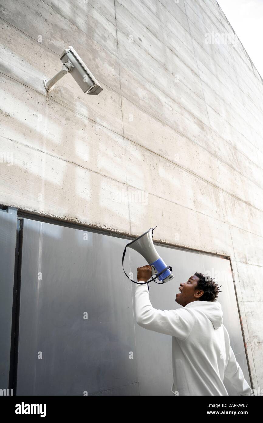 Mature man holding megaphone and screaming Stock Photo - Alamy