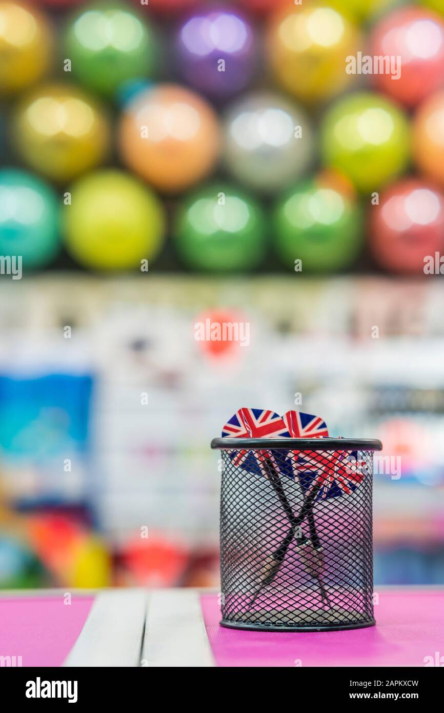 Balloons and darts at fairground booth Stock Photo - Alamy