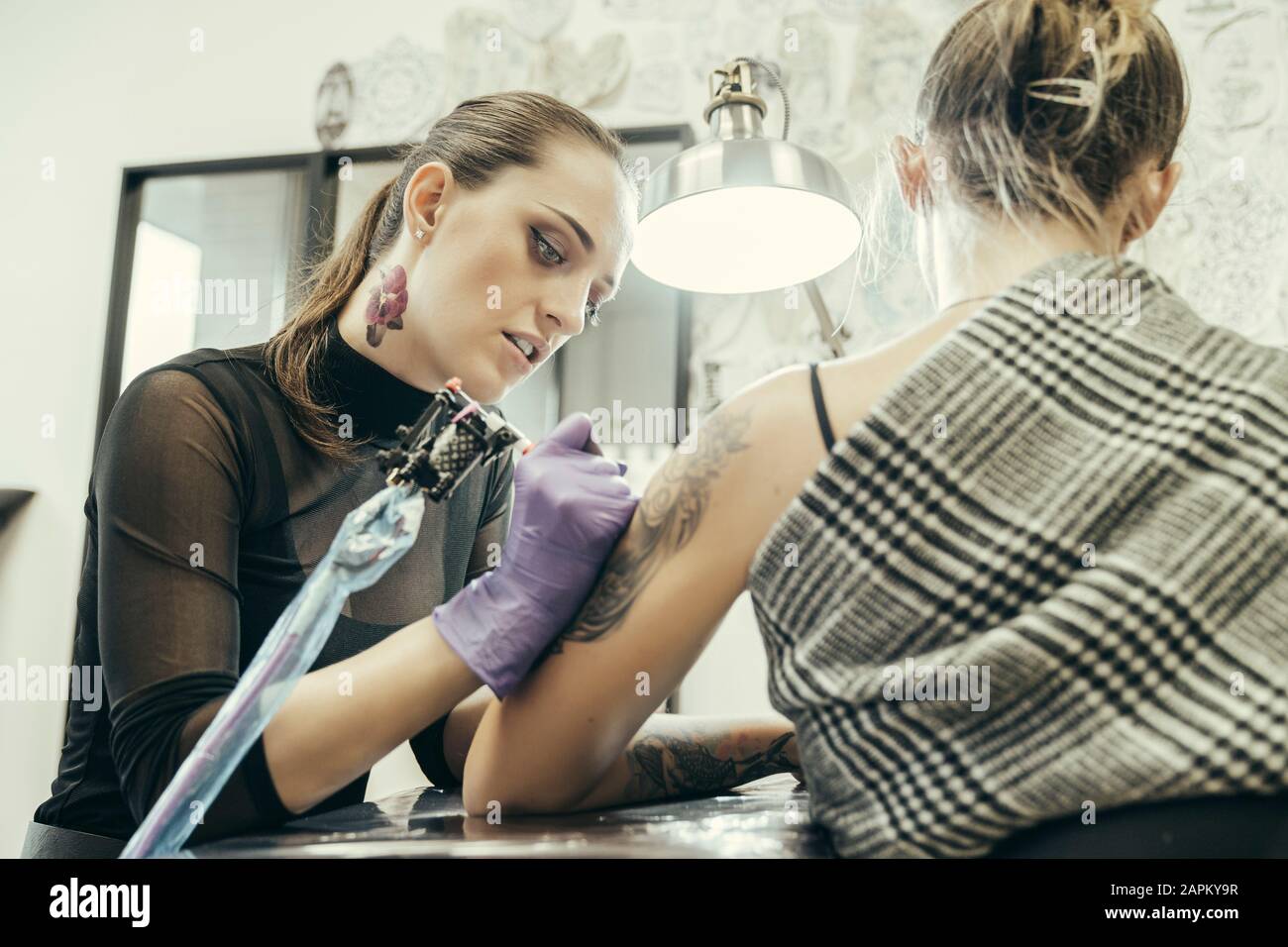 Tattooing arms hi-res stock photography and images - Alamy