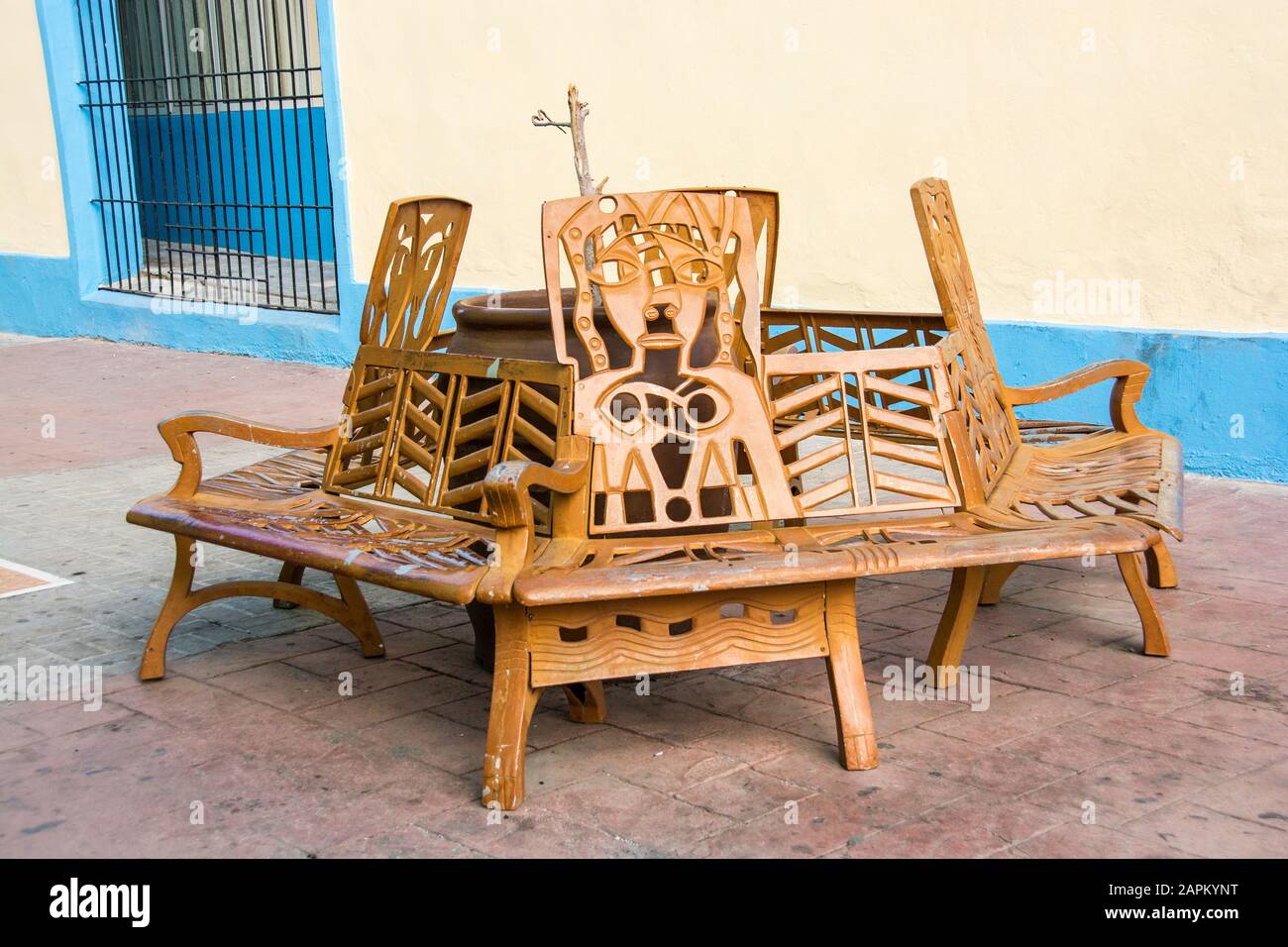 Benches at an outdoor mall encourage people to sit down and take a rest ...