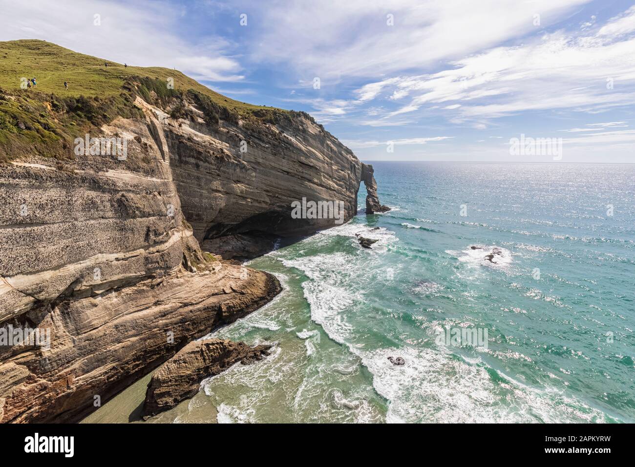 New Zealand, Cliffs and natural arch of Cape Farewell headland on sunny ...
