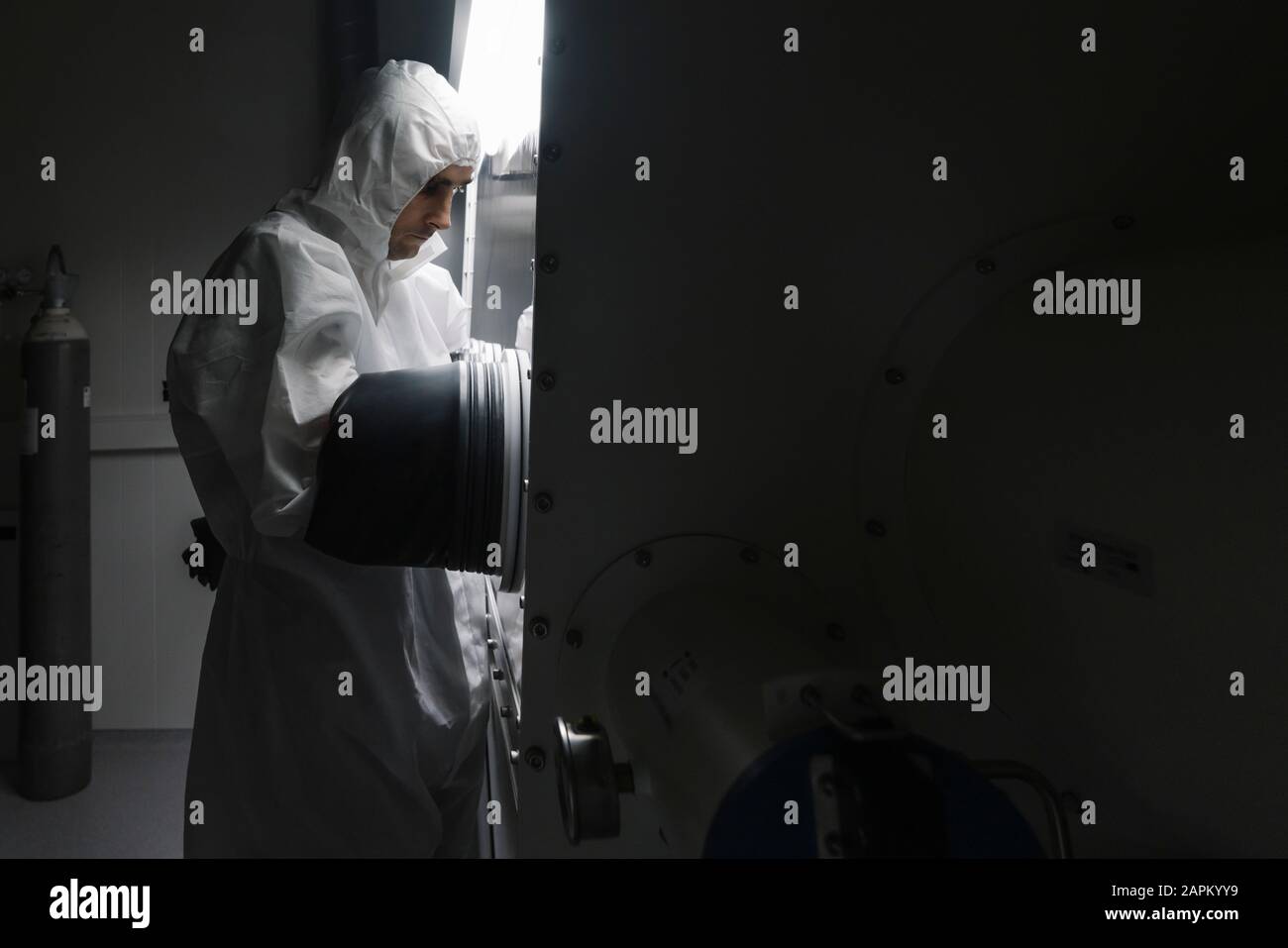 Scientist in clean suit working hi-res stock photography and images - Alamy