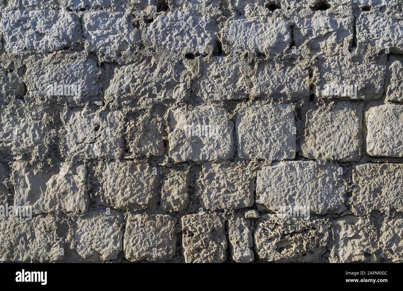 Closeup of an old grey stone wall Stock Photo - Alamy