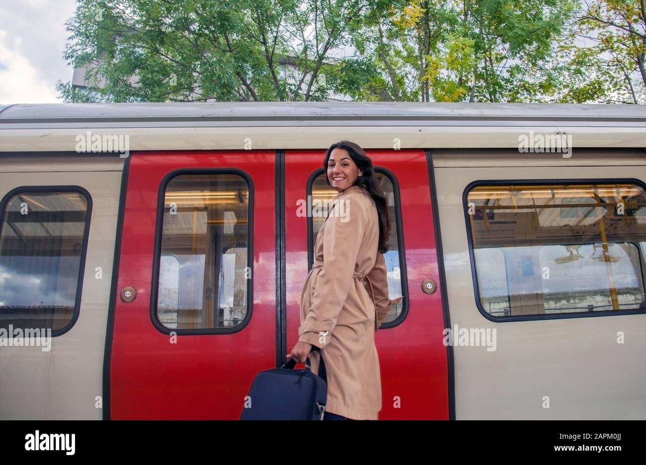 Young woman taking the commuter train Stock Photo - Alamy