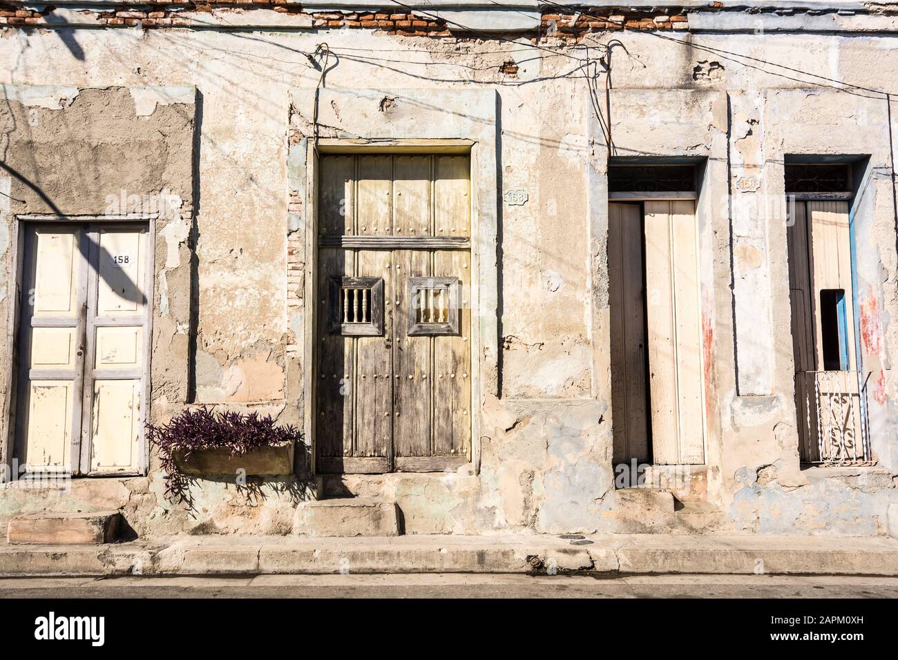 The front facade of a home, featuring a rustic wooden door; Santiago de ...