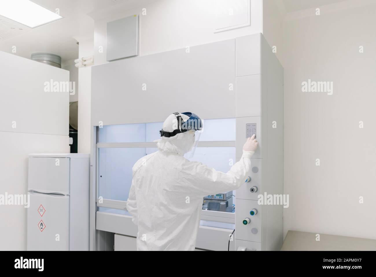 Researcher wearing safety helmet working in laboratory Stock Photo - Alamy