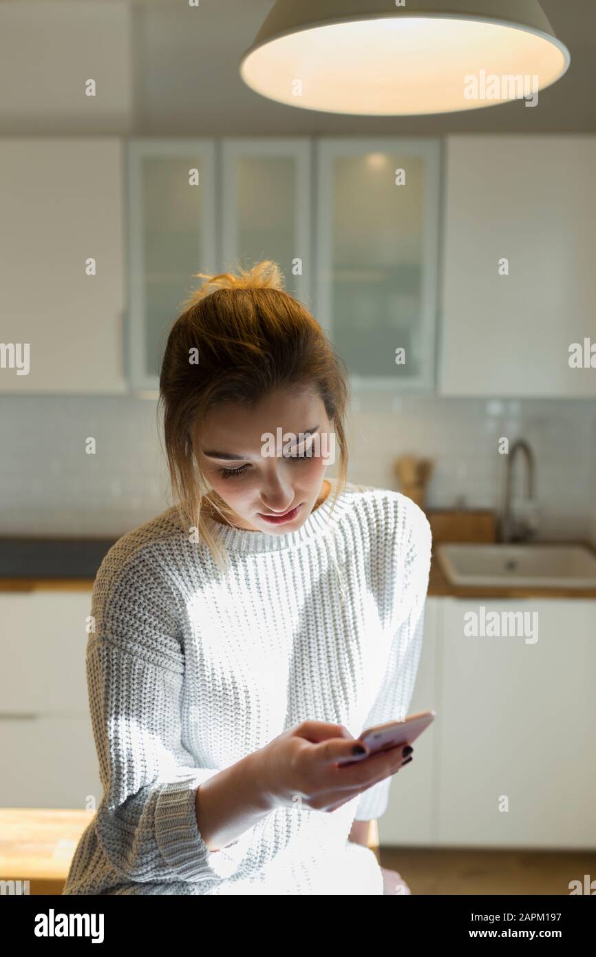 Young woman using smartphone at home Stock Photo - Alamy