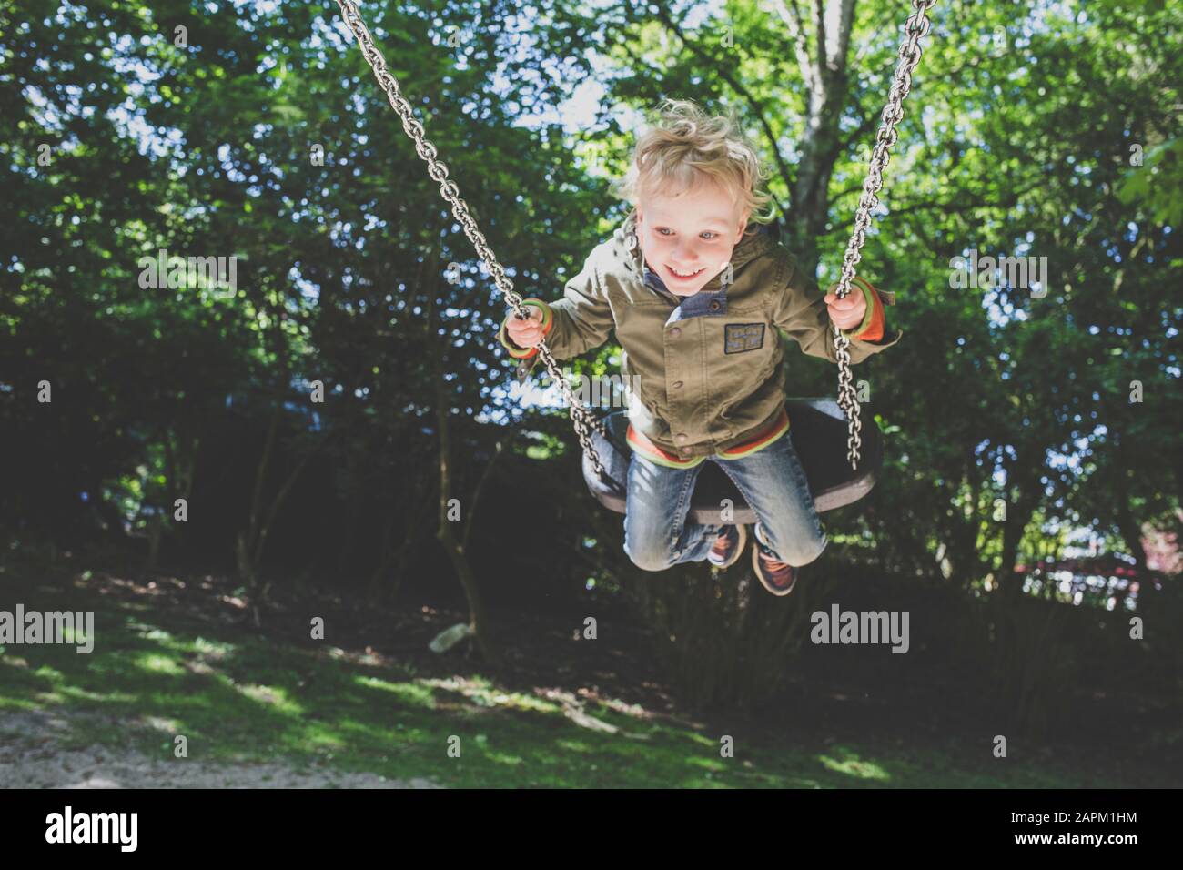Children on swingset hi-res stock photography and images - Alamy