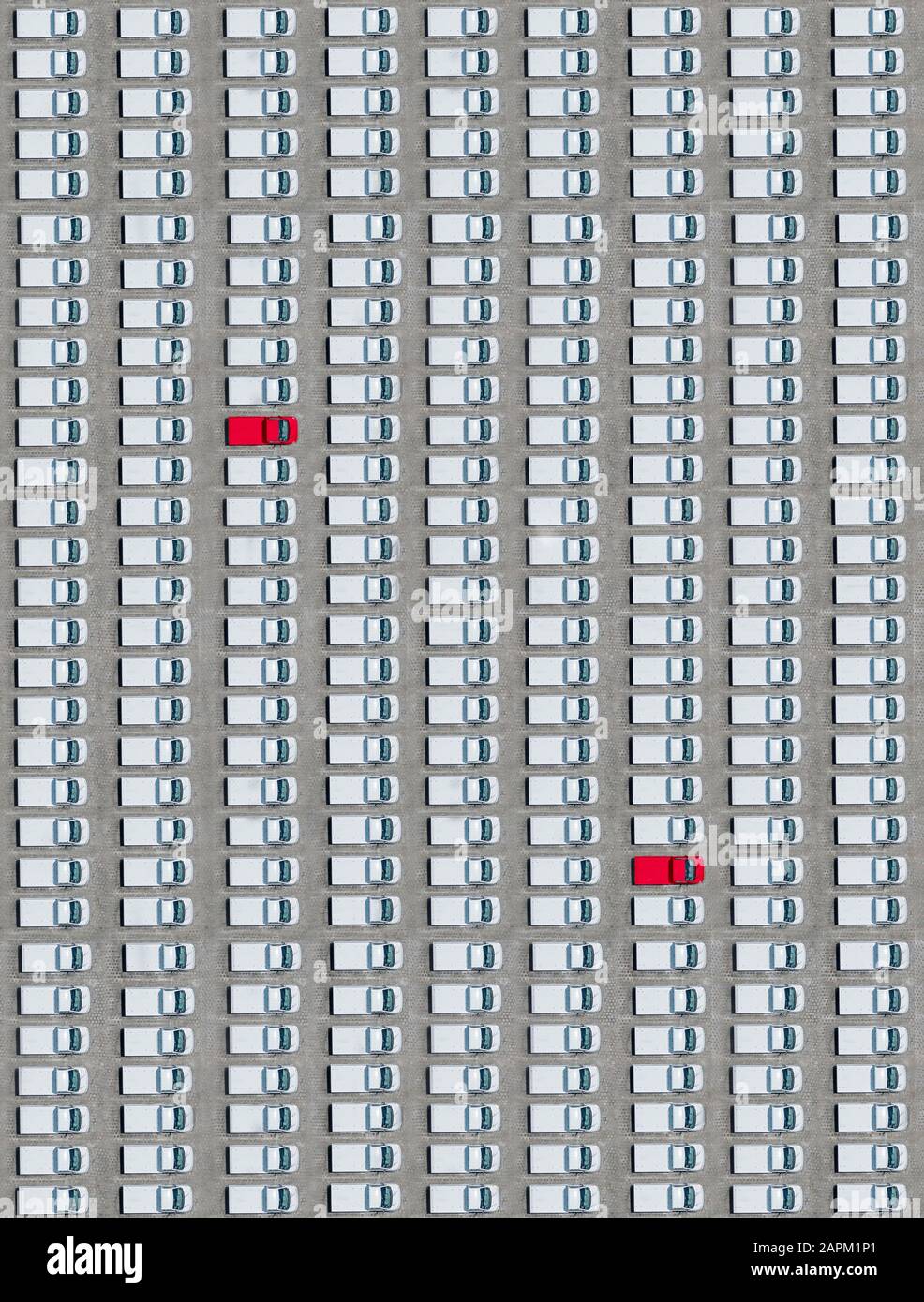 Aerial view of two red cars parked amid only white ones Stock Photo - Alamy