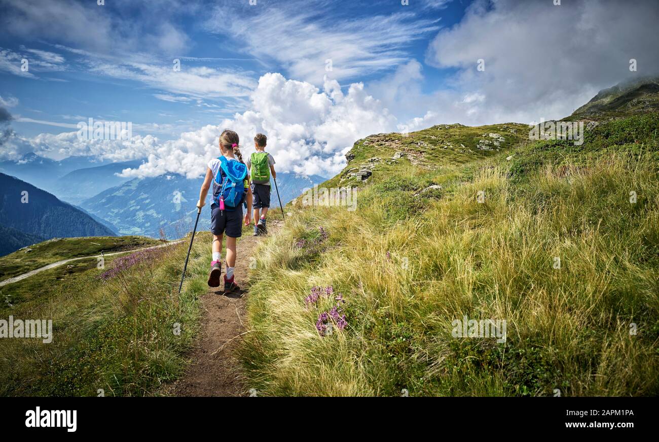 Boy and girl hiking in alpine scenery, Passeier Valley, South Tyrol ...