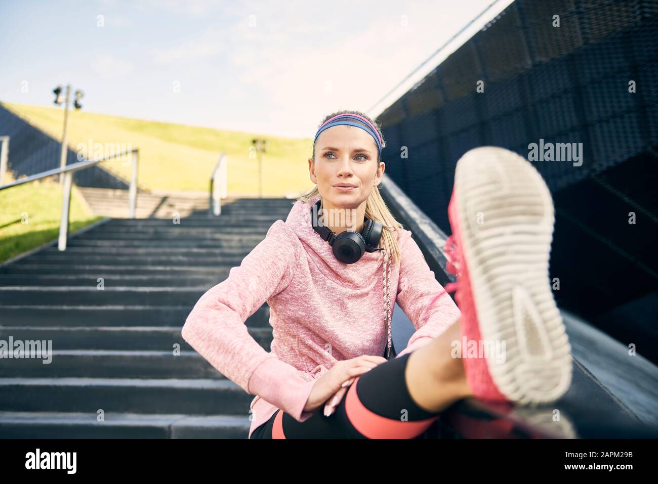 Fit blonde runner woman warming hi-res stock photography and images - Alamy