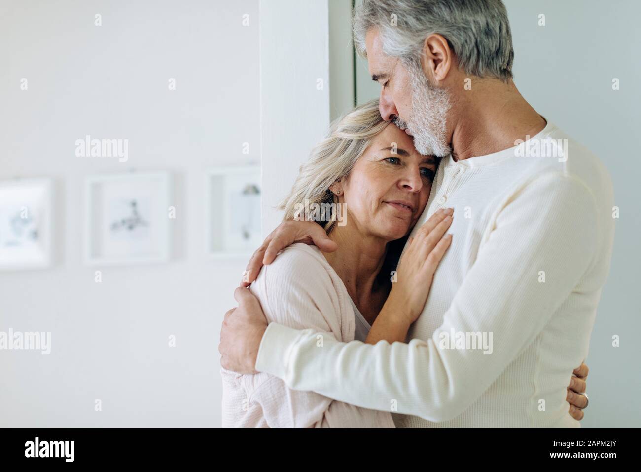 Affectionate mature couple hugging at home Stock Photo - Alamy