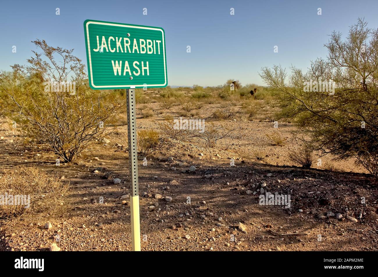 A road sign pointing the way to a dry creek in the Arizona desert named ...