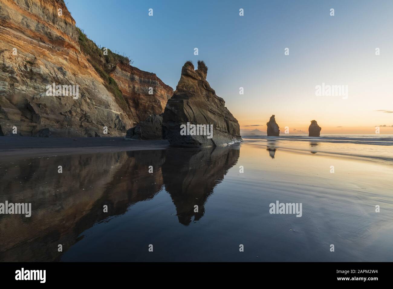 Three sisters rock formation reflecting wet shiny beach sand hi-res ...