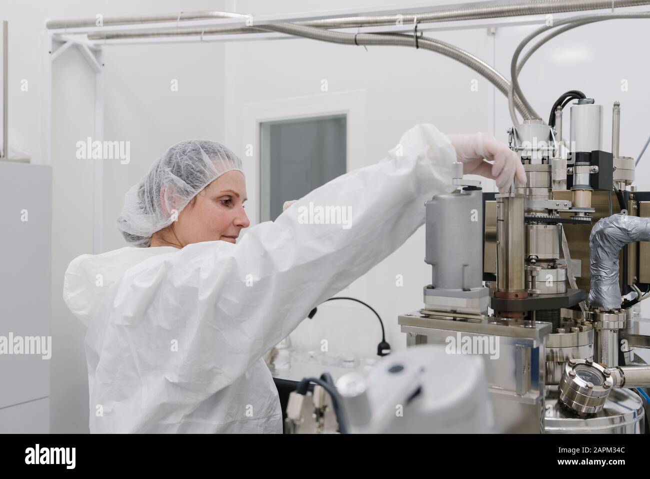 Laboratory technician working on a device in laboratory of science ...