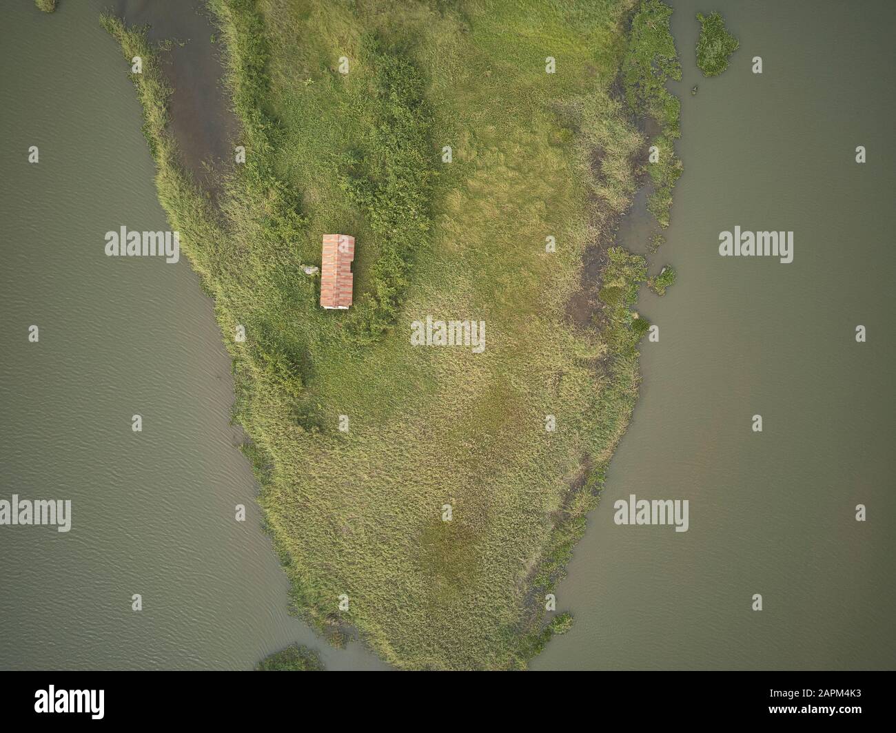 Benin, Grand Popo, Aerial view of secluded house on shore of green ...