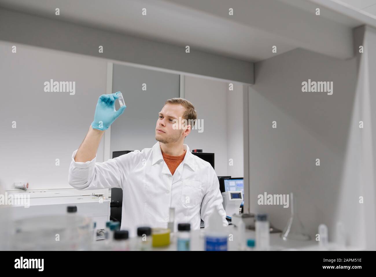 Scientist analyzing a specimen in laboratory Stock Photo - Alamy