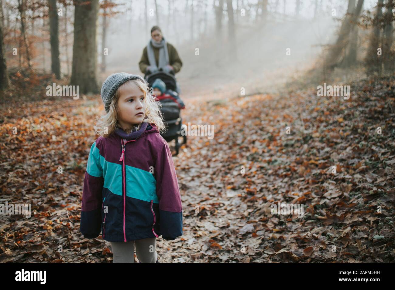 Mother with daughters during forest walk in autumn Stock Photo - Alamy