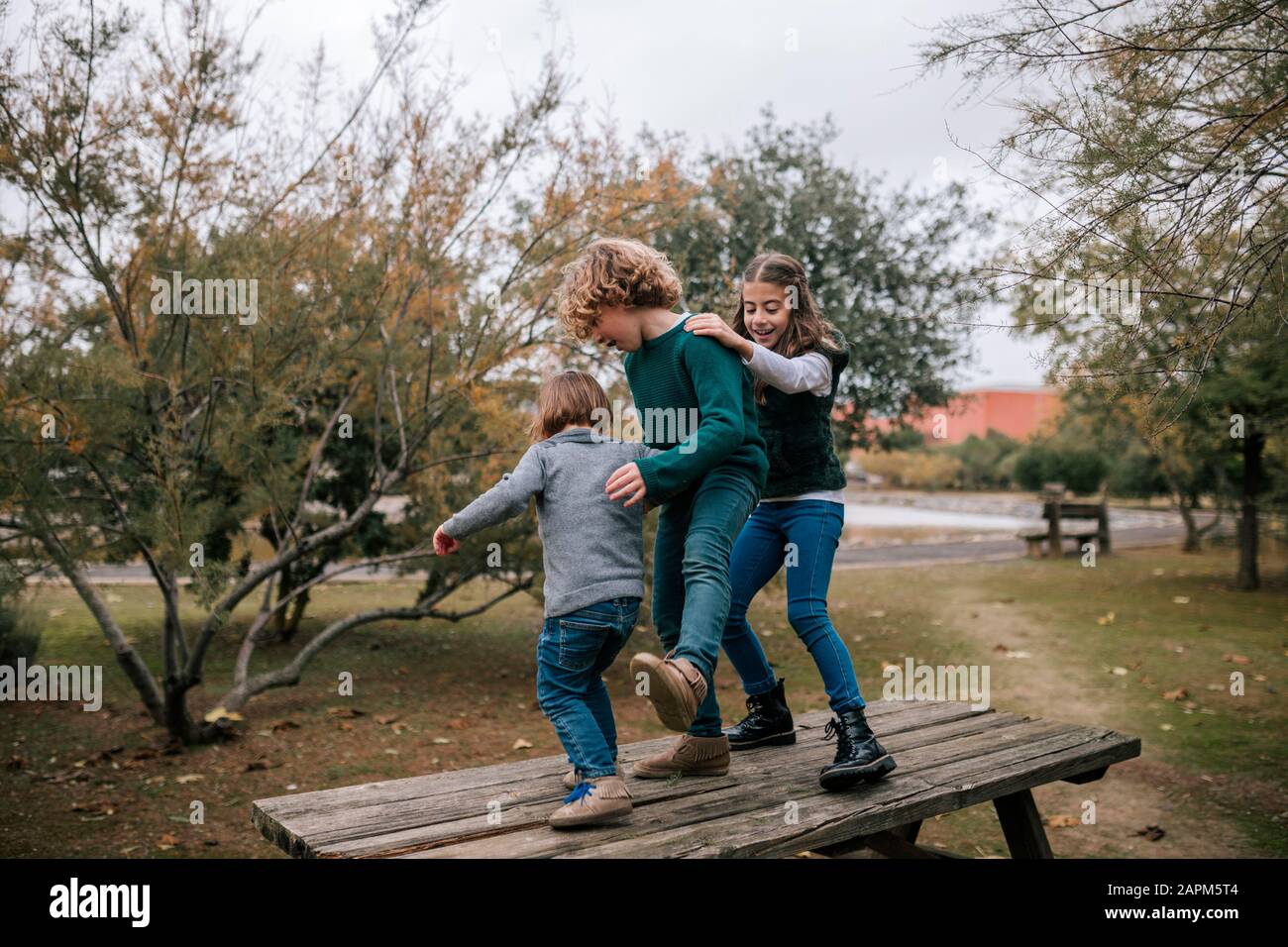 Three children stand hi-res stock photography and images - Alamy