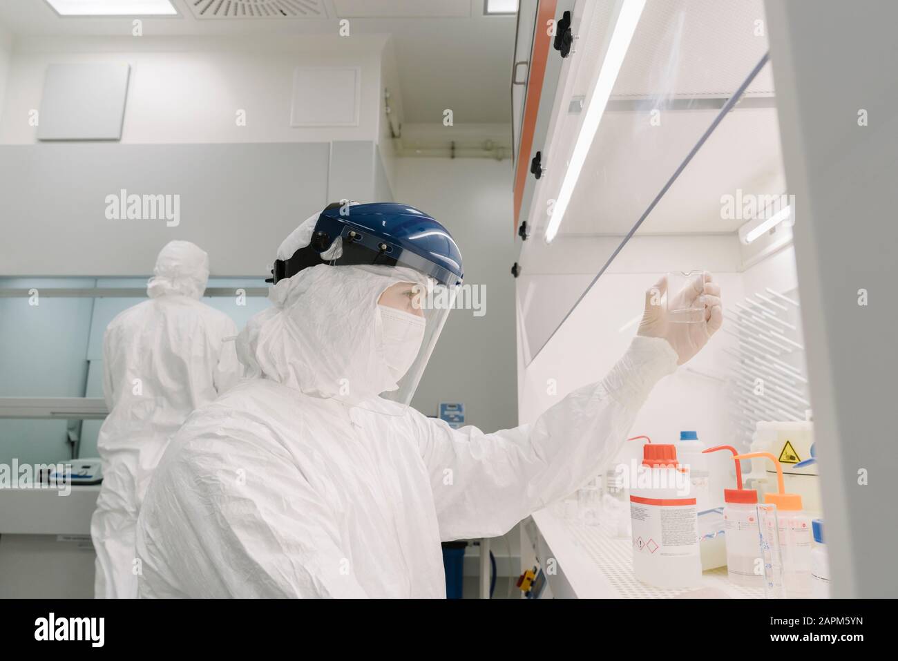 Researcher wearing safety helmet working in laboratory Stock Photo - Alamy