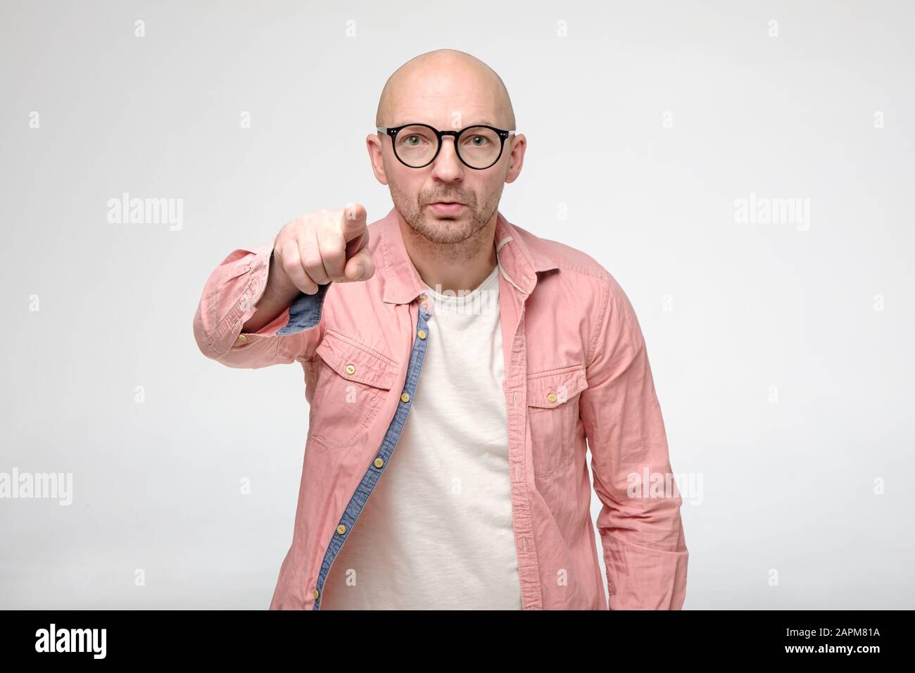 Worried man accuses someone by pointing finger at the guilty person and ...