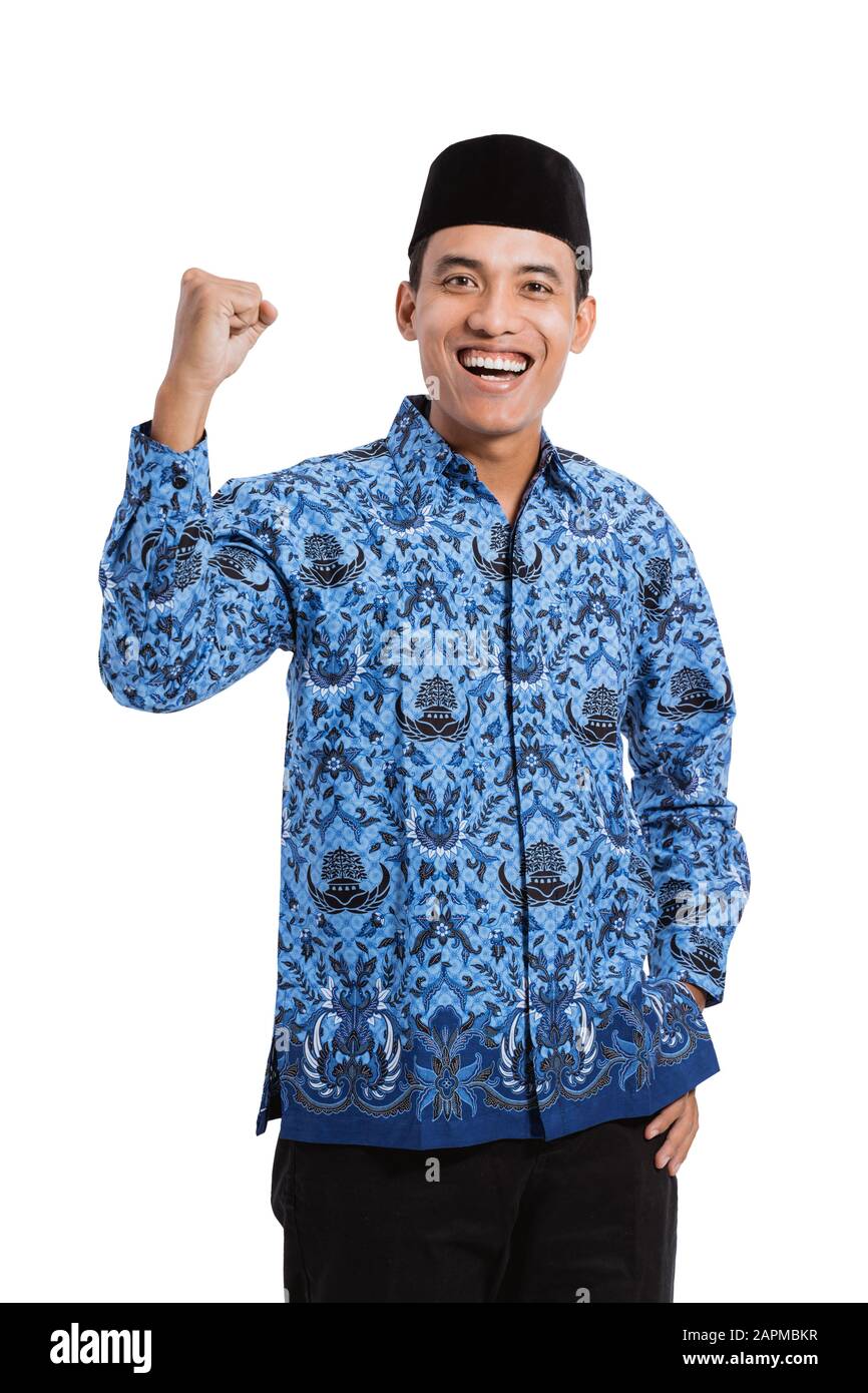 smiling asian young man wearing batik korpri with spirited hand gesture ...