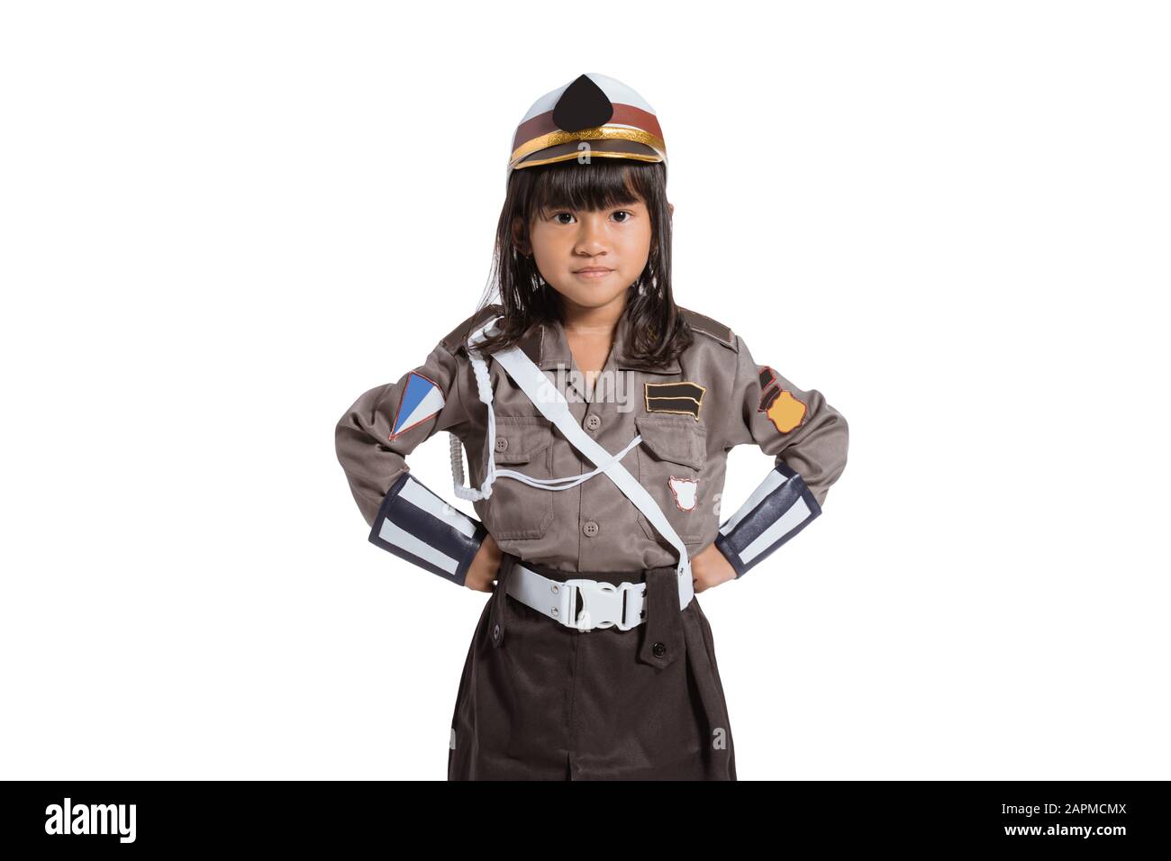 Asian little girl wearing a police uniform with two hands on her waist ...