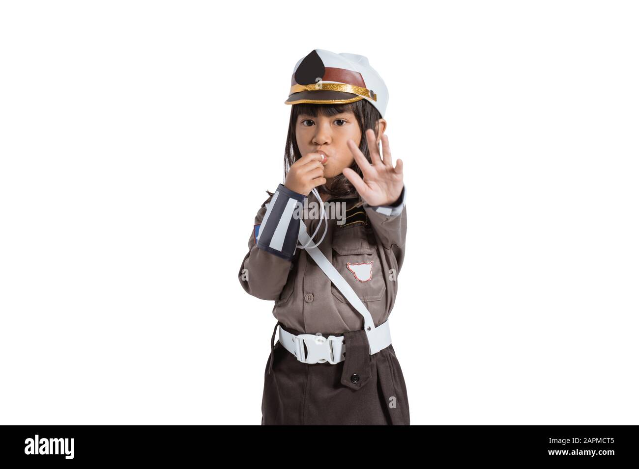 Asian little girl wearing a police uniform with a whistle blowing and ...