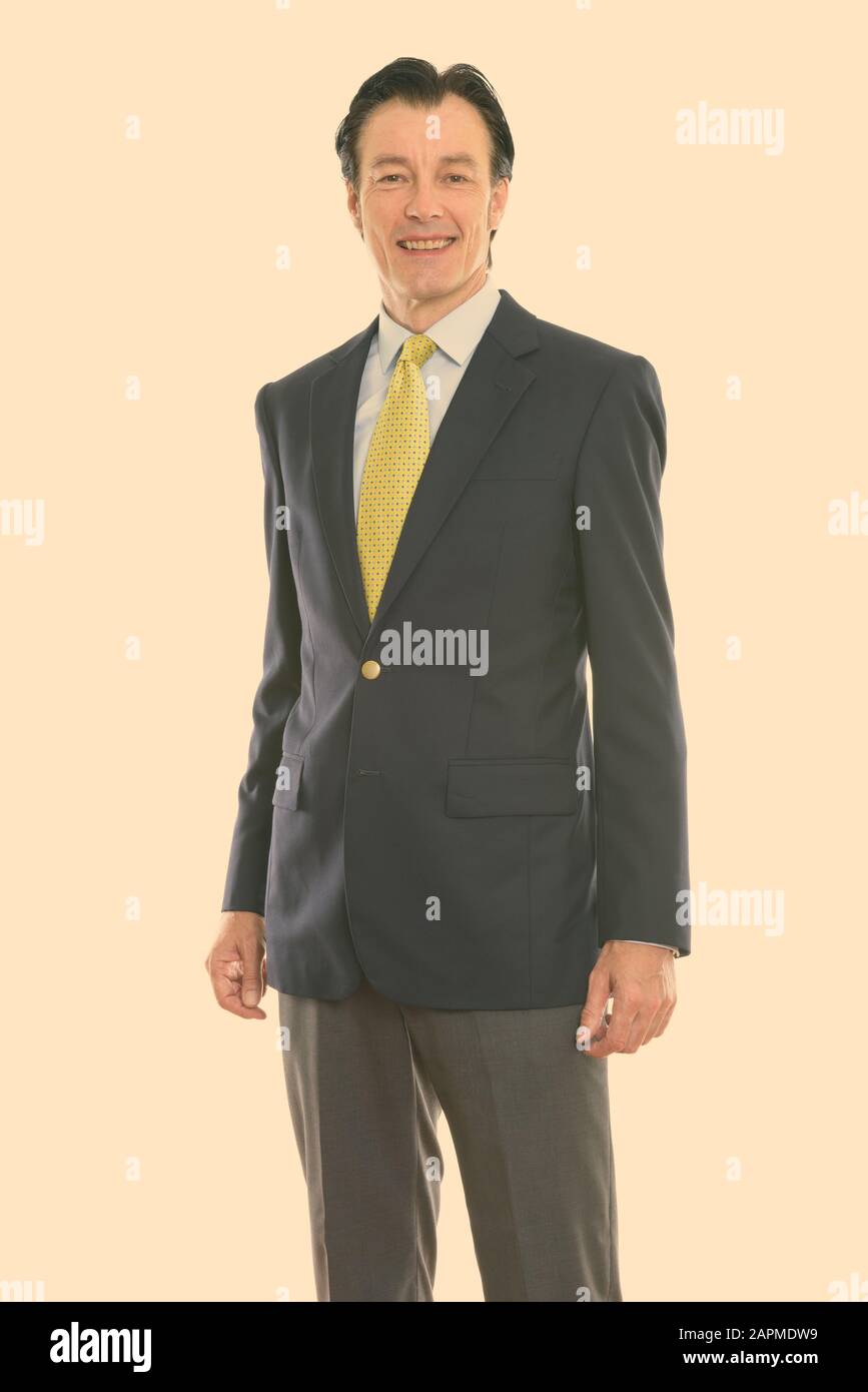 Handsome businessman smiling standing hi-res stock photography and ...
