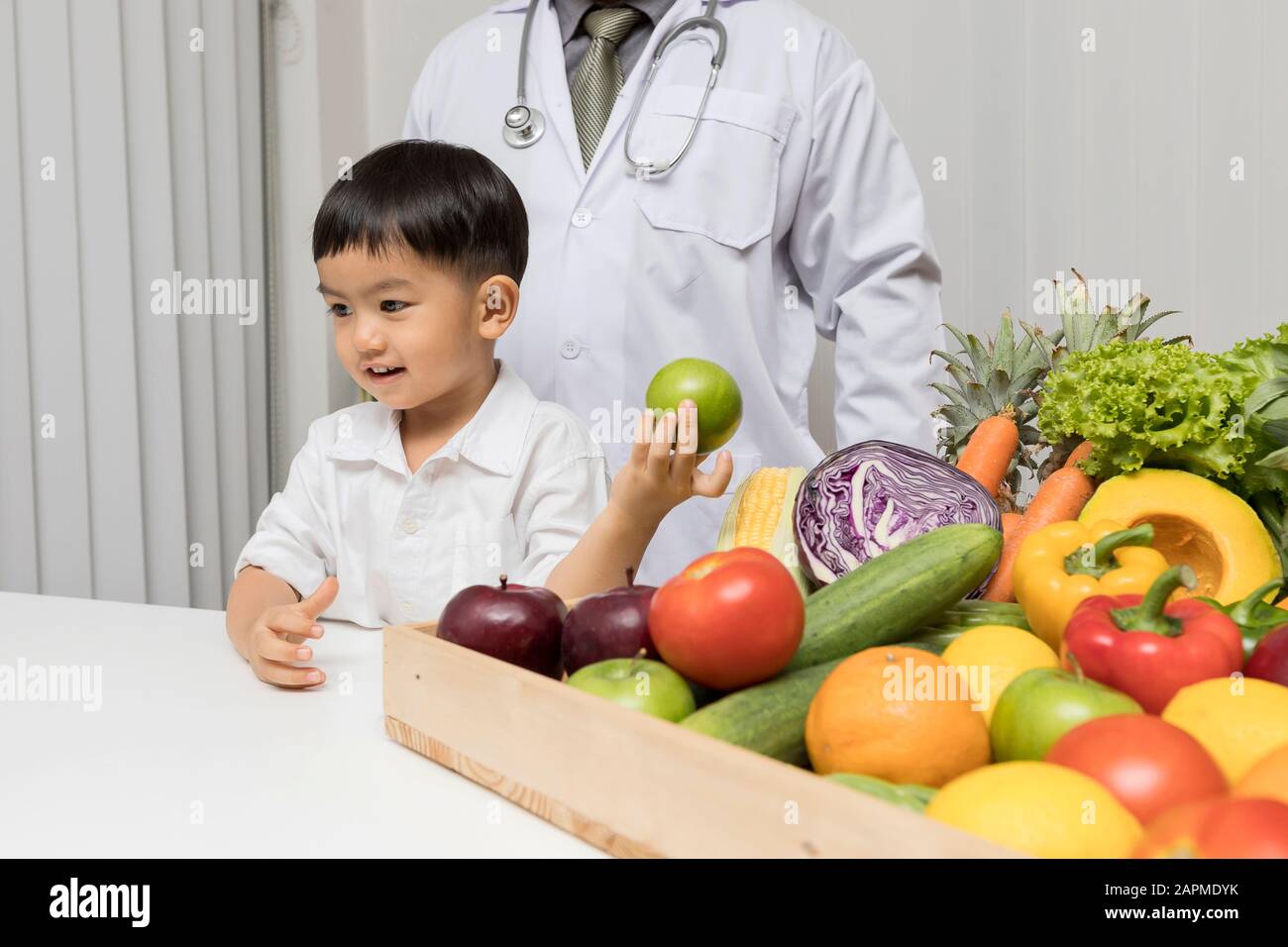 A boy and doctor happy to have healthy food. Kid learning about ...