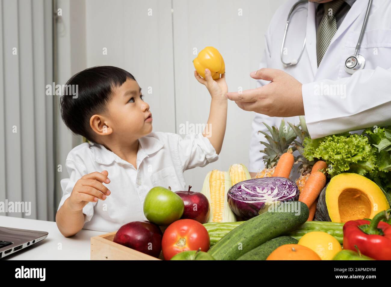 A boy and doctor happy to have healthy food. Kid learning about ...