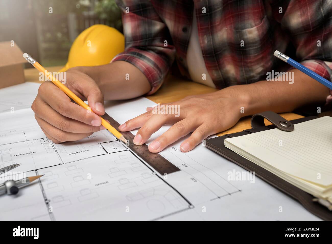 Architect measuring scale on blueprint in construction site Stock Photo ...